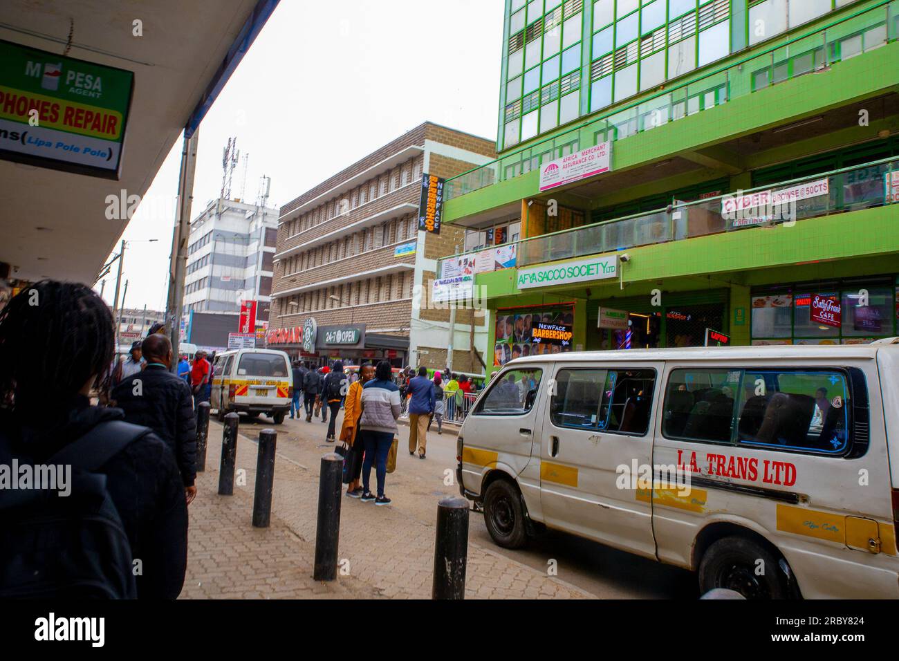 NAIROBI, KENYA-JULY 04, 2023: Pedestrians walk through the busy streets ...