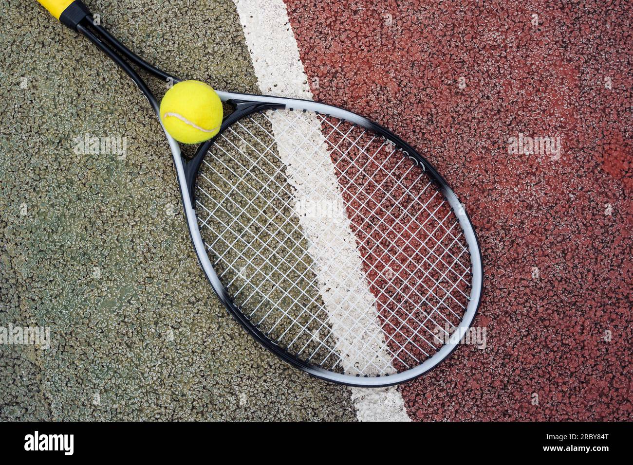 Closeup top view on tennis ball and racket racquet lying on acrylic ...
