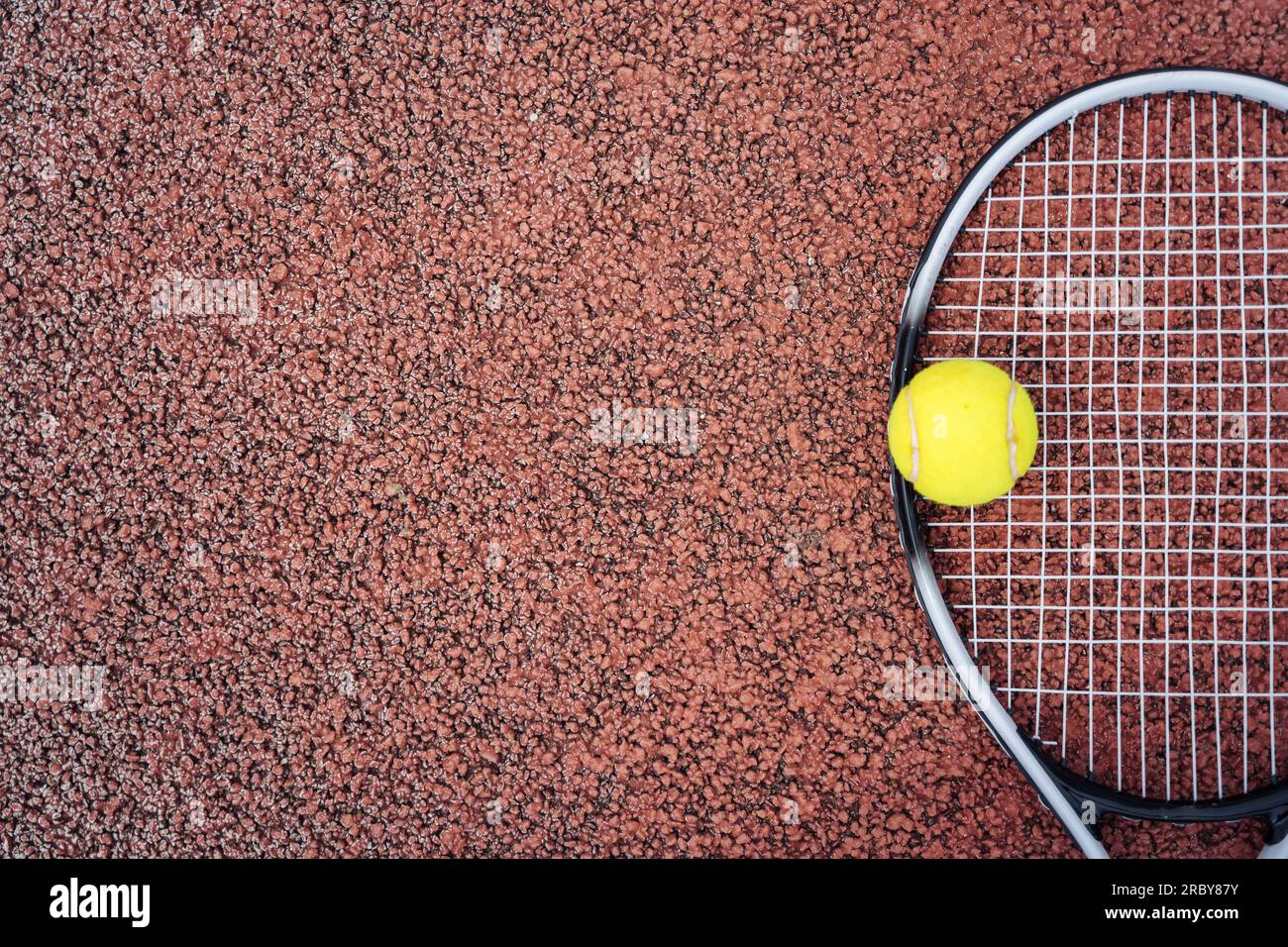 Closeup top view on tennis ball and racket racquet lying on acrylic ...