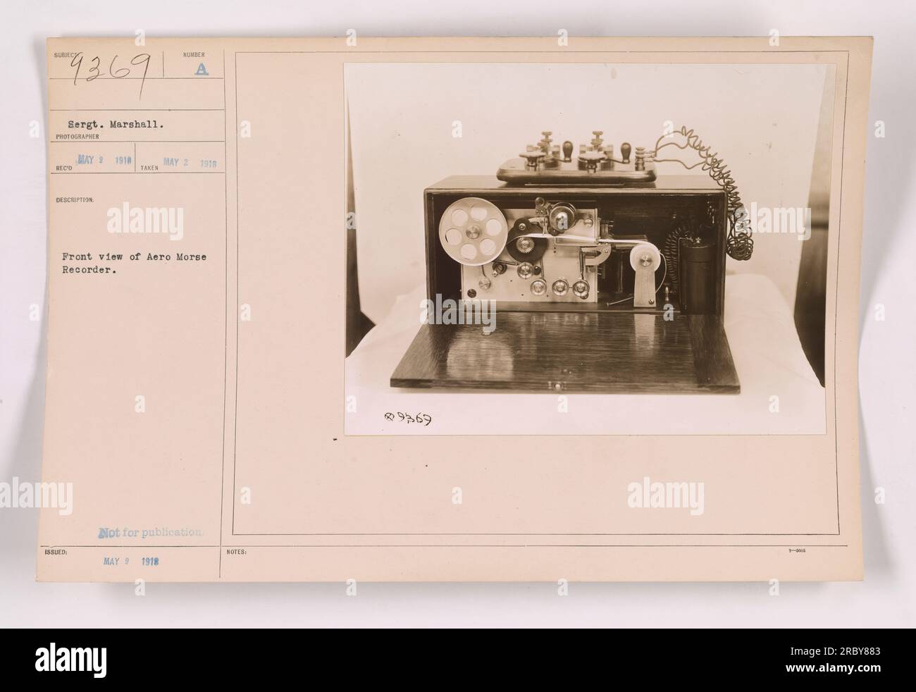 The image depicts Sgt. Marshall operating an Aero Morse Recorder during ...