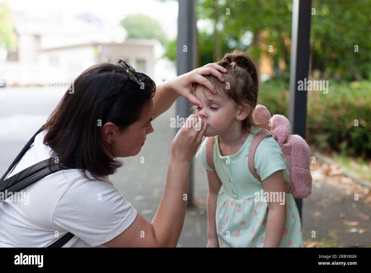 Mother and daughter are looking at each other and crying in the street ...
