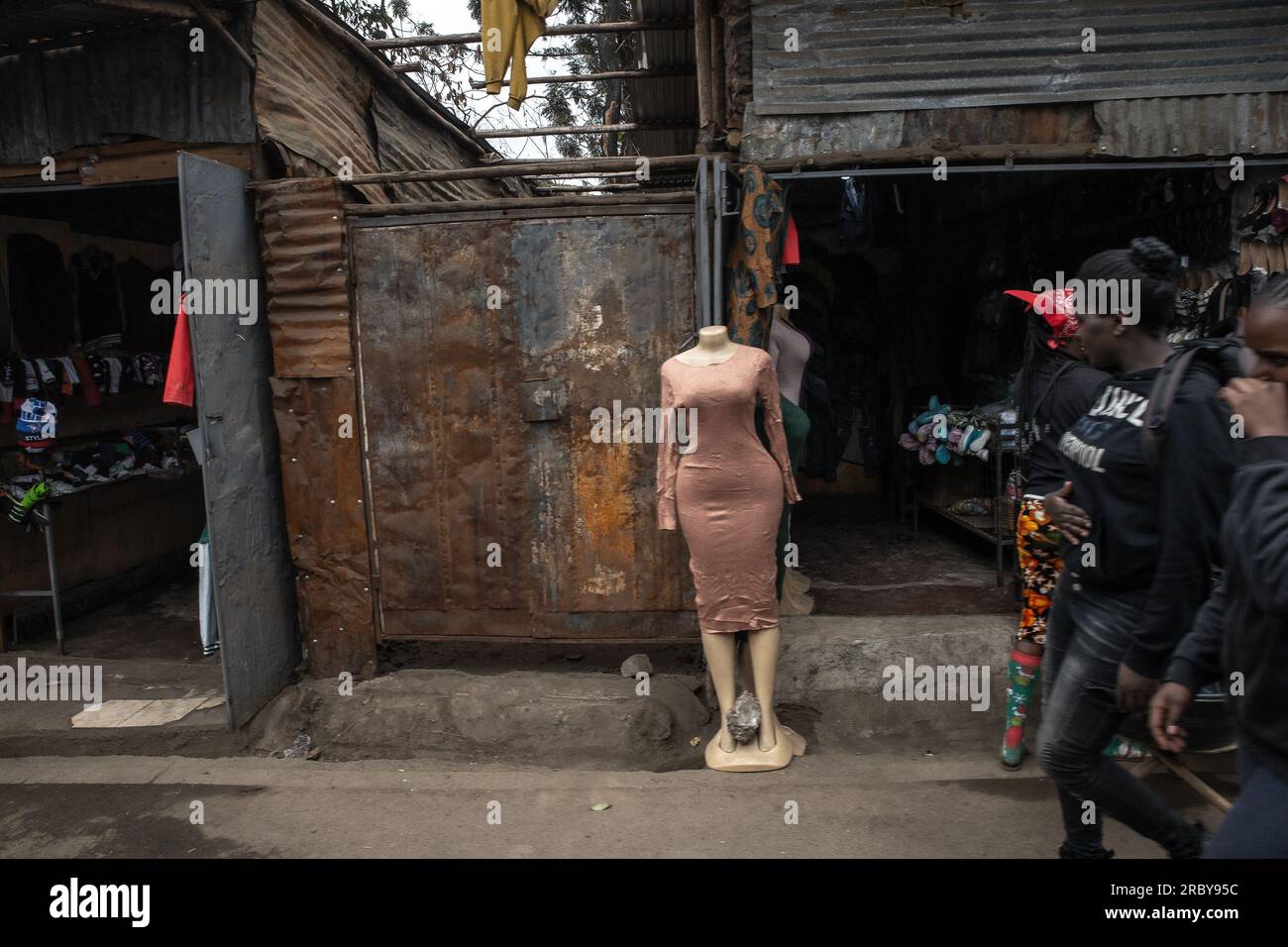 NAIROBI, KENYA-JULY 04, 2023: Residents walk past the streets in Kibera ...