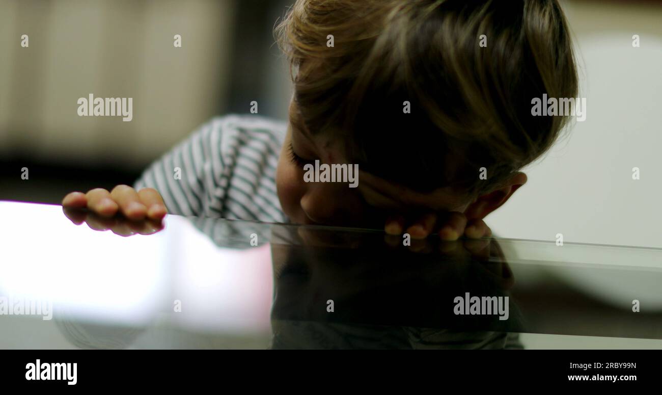 One sleepy child leaning on table falling asleep Stock Photo - Alamy
