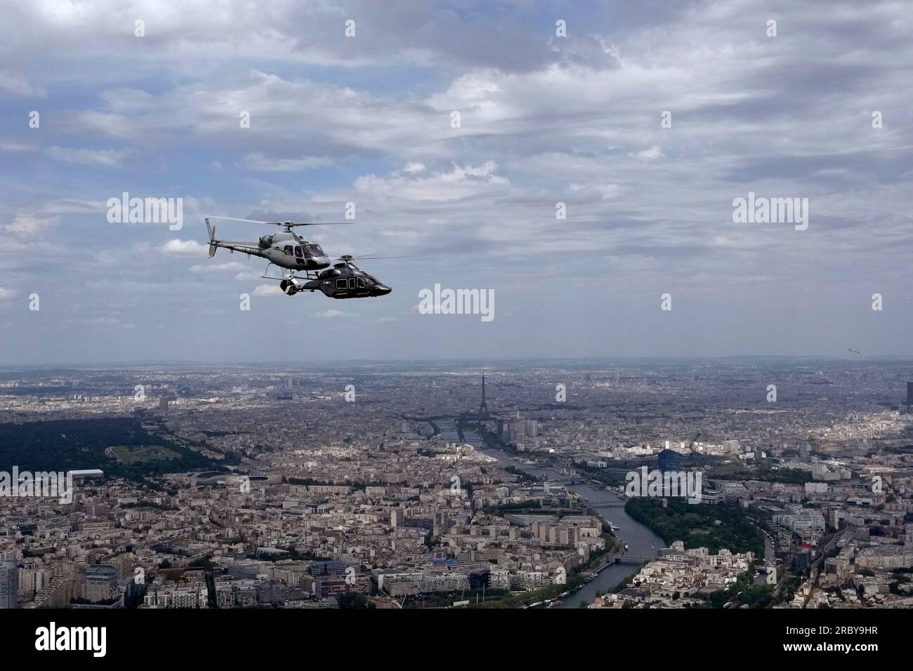 A French army Fennec helicopter, left, and an Airbus H160 fly over ...