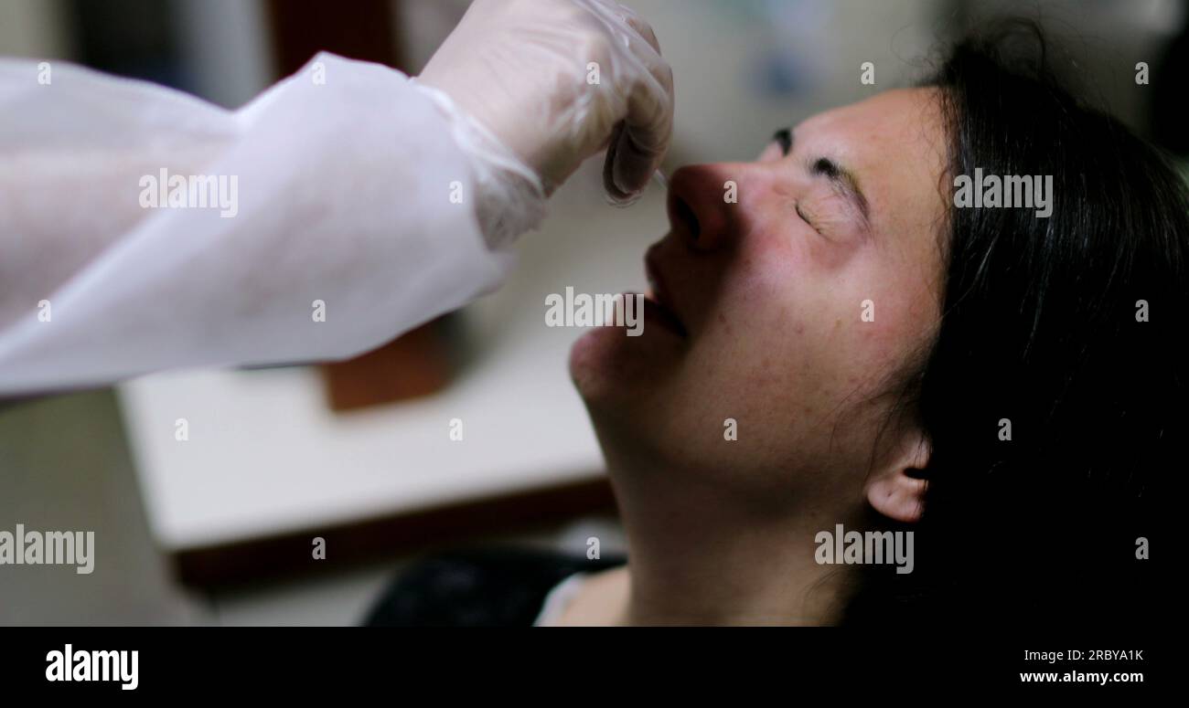 Woman having COVID nose test PCR procedure Stock Photo - Alamy