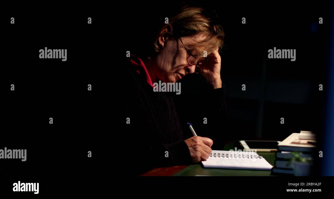 Pensive older woman writing notes hi-res stock photography and images ...
