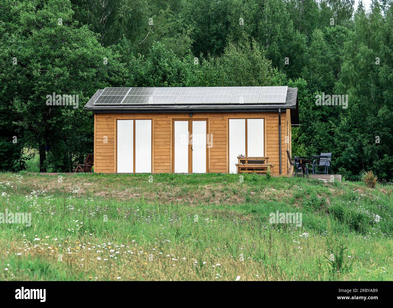 Wooden house among green trees, remote secluded place Stock Photo - Alamy