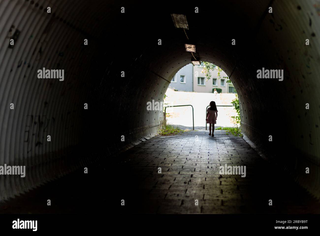 Woman walking through tunnel rear view hi-res stock photography and ...
