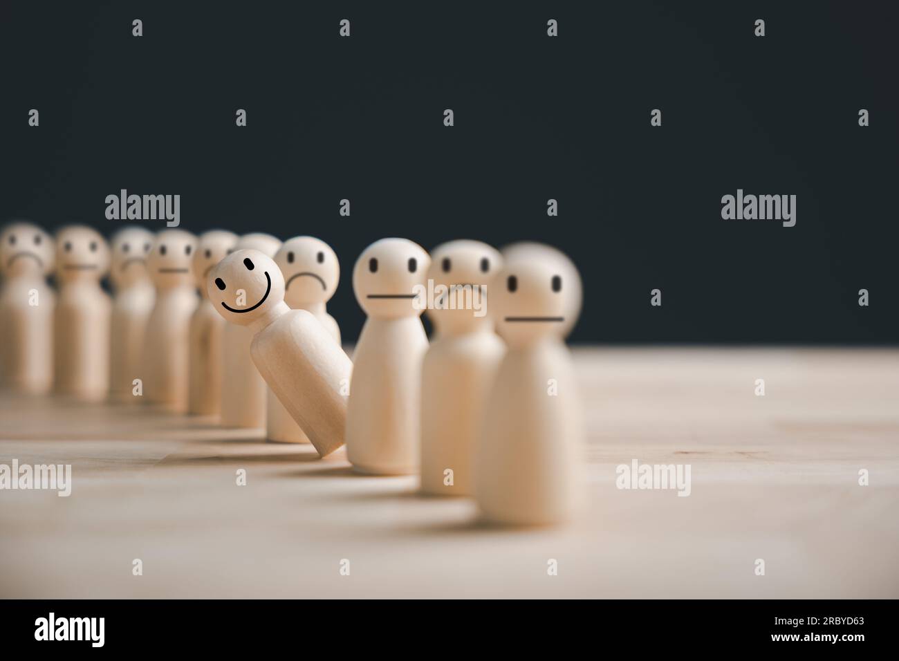 Hand choosing a wooden figure as the chosen leader from the crowd Stock ...