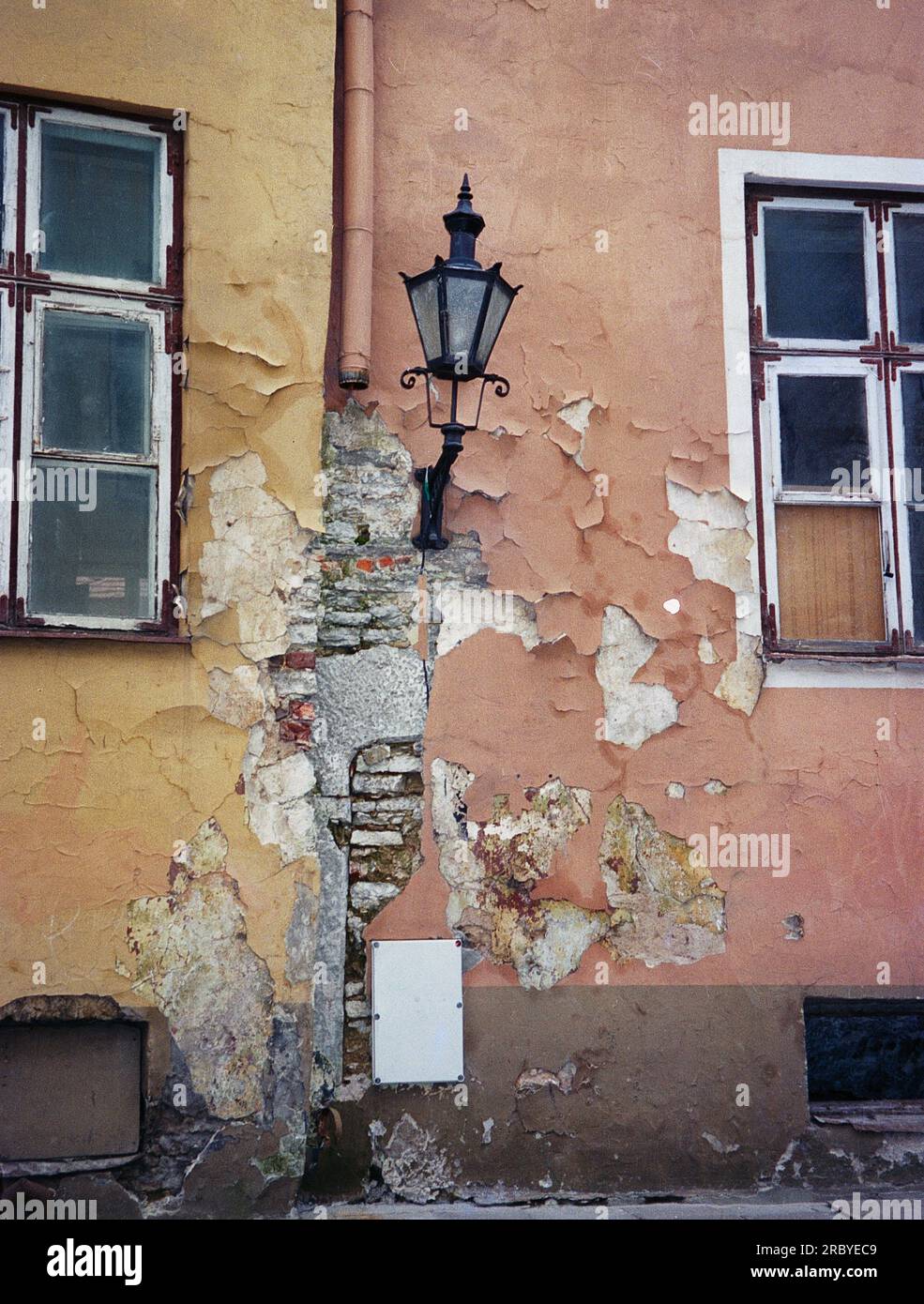 Decaying broken paint and rendering under a street light on a Tallinn ...