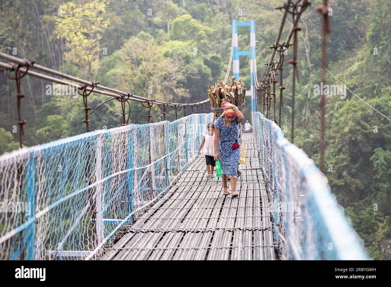 Local khasi people crossing iron hanging bridge over the umngot or ...
