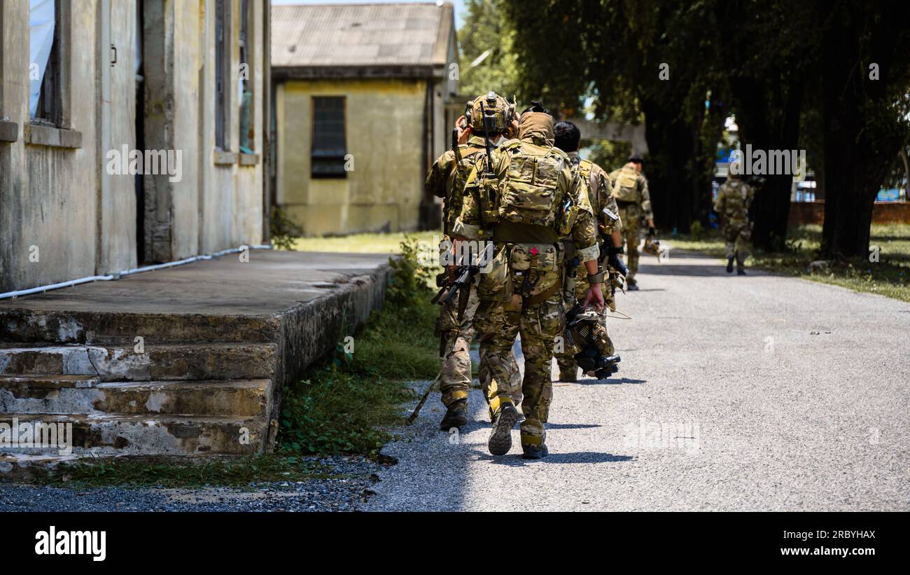 Expert team of soldiers attacking enemy during military operation, Army ...