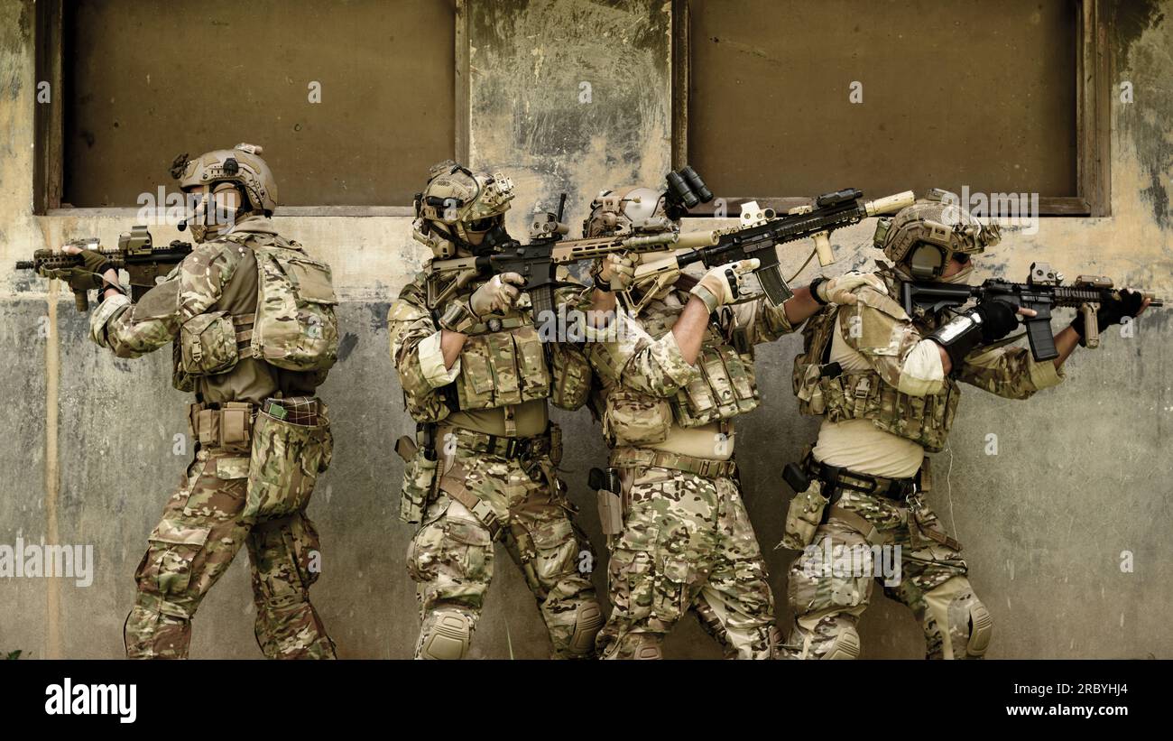 Squad of soldiers running forward and attacking enemy during military ...