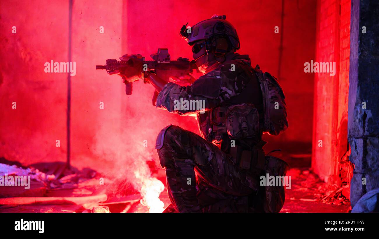 Expert team of soldiers with weapons attacking enemy during military ...