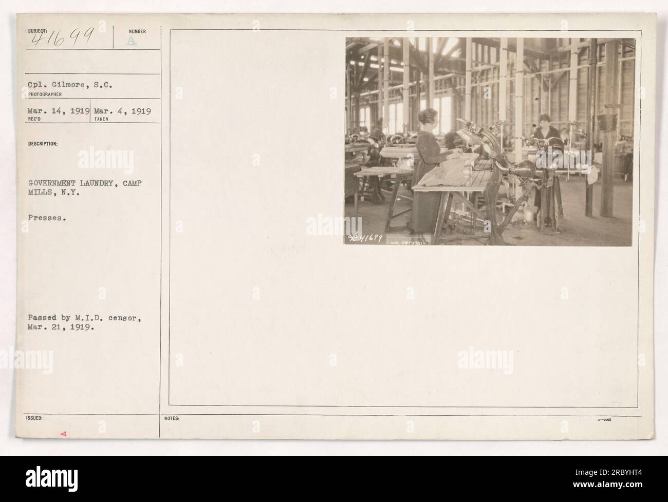 Soldier operating a pressing machine in the government laundry facility ...