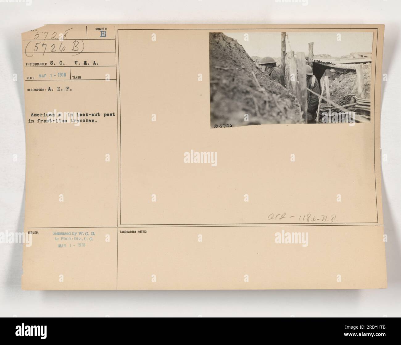 American soldiers stationed in a front-line trench keep watch from a ...