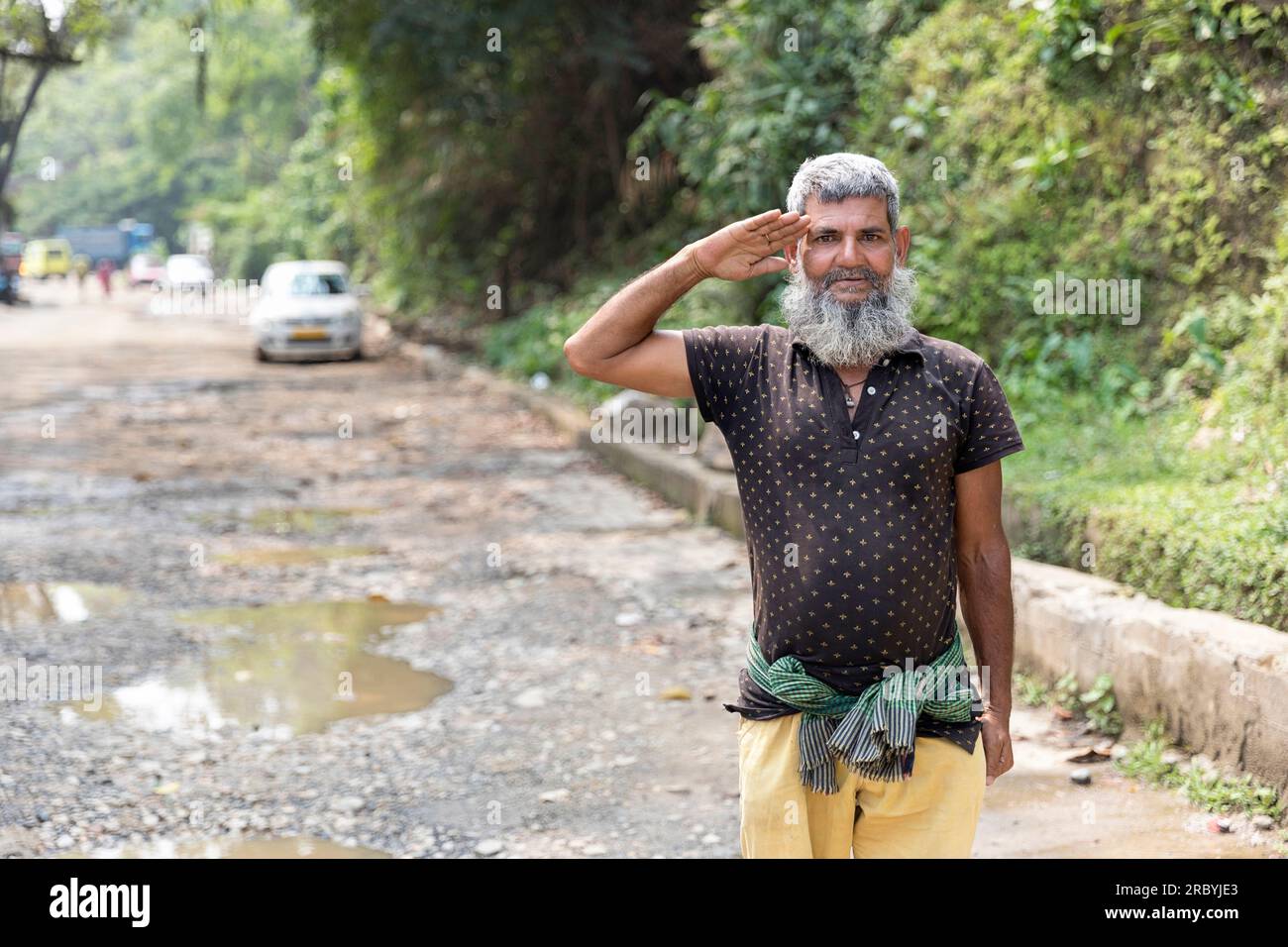 Old or senior man saluting on the road at Indo Bangladesh border ...