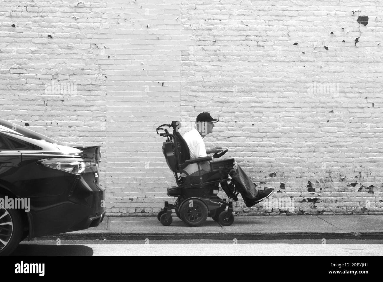 Man in an electric wheelchair Black and White Stock Photos & Images - Alamy