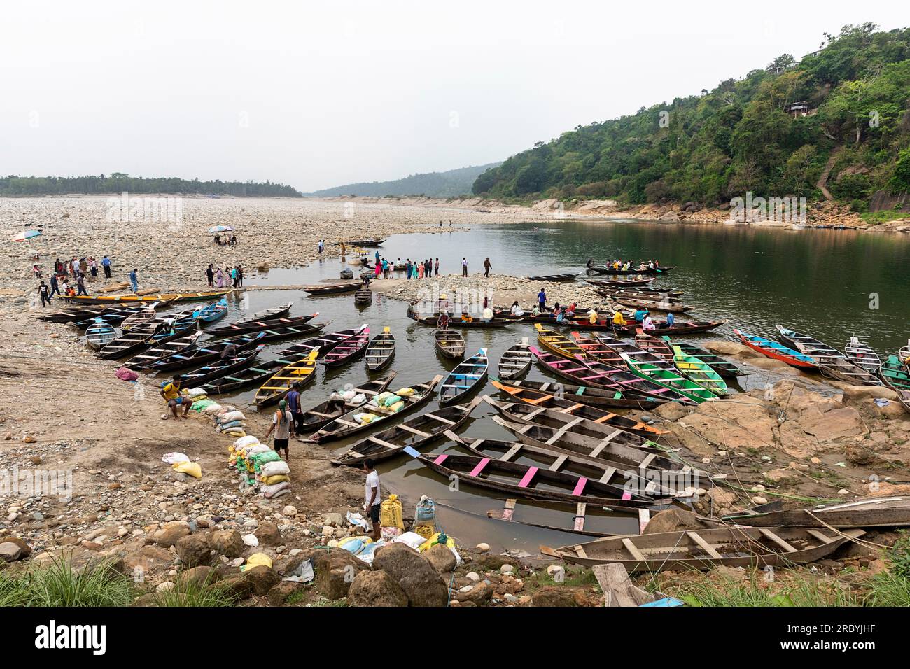 Traditional colourful wooden boats on dawki river parked on a river ...