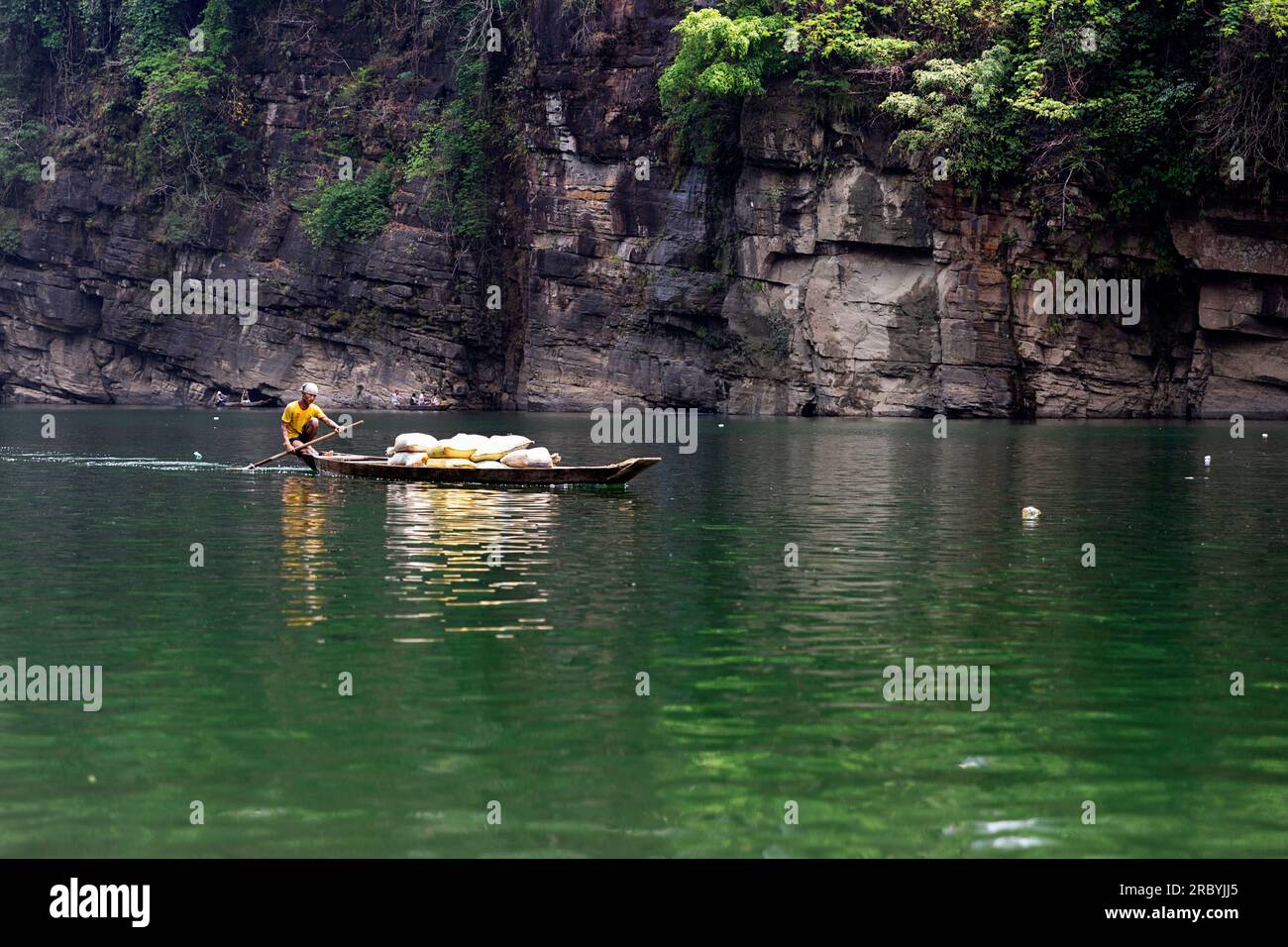 Fisherman fishing for his daily needs with traditional wooden boat at ...