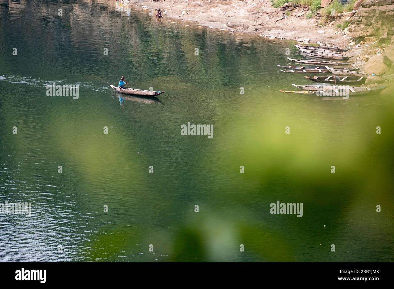 Local fisherman paddling in a Traditional colourful wooden boat on ...
