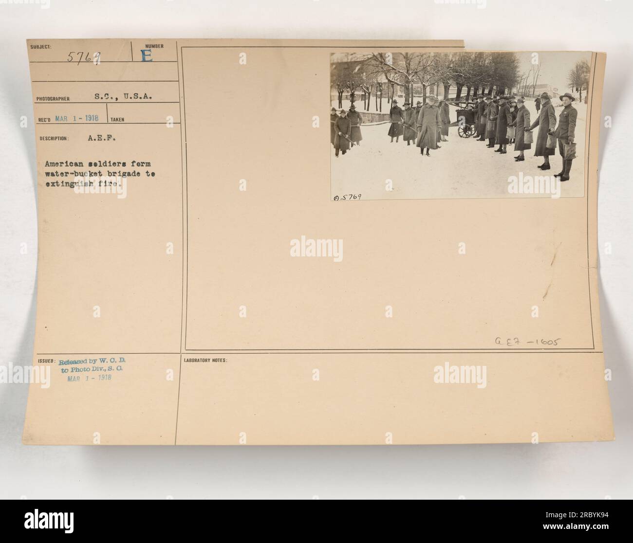 American soldiers from the A.E.P. number E form a water-bucket brigade ...