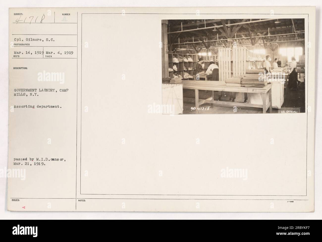 Members of the American military engaged in the task of sorting laundry ...