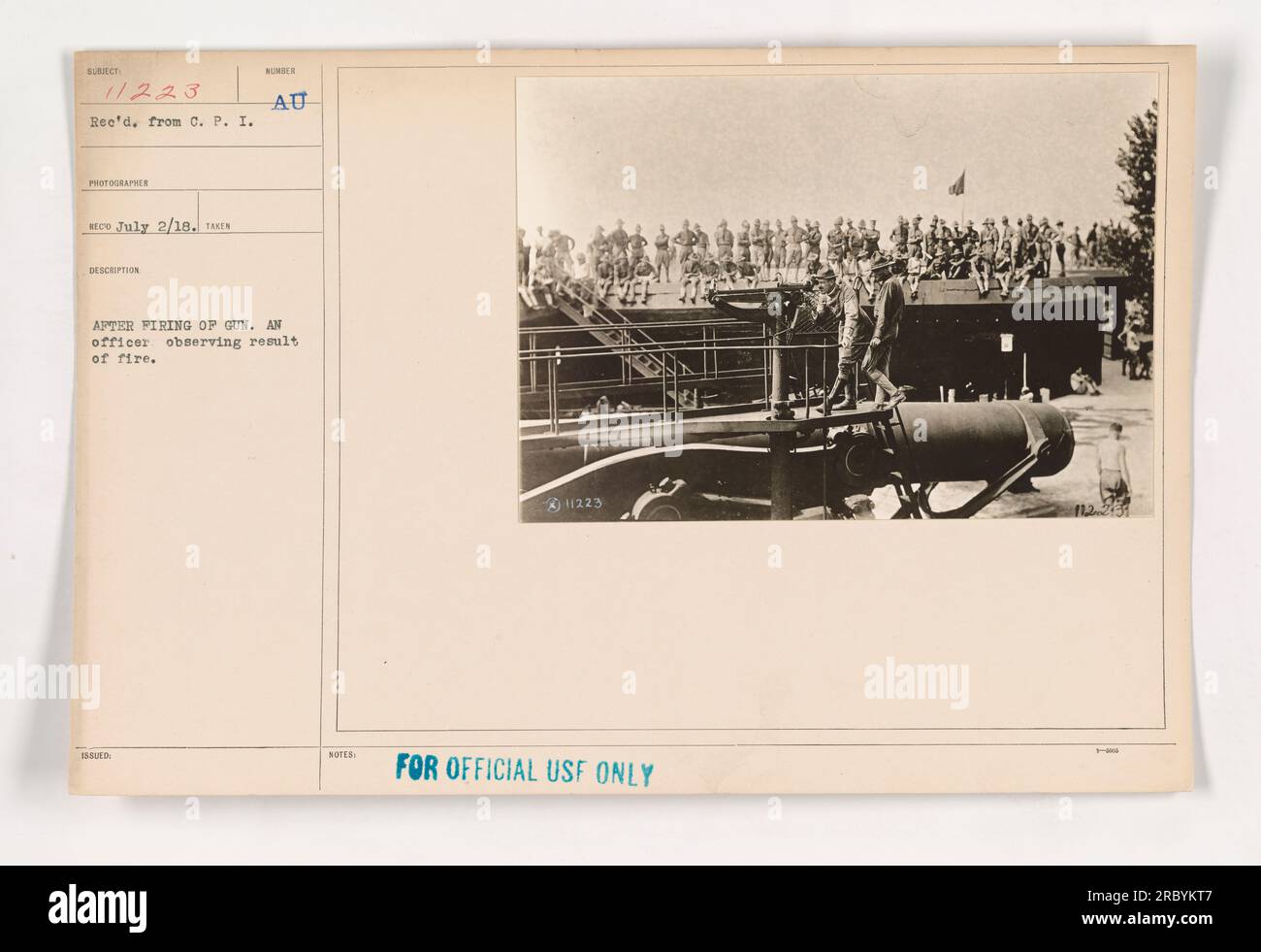 An officer observes the result of firing a gun during military ...