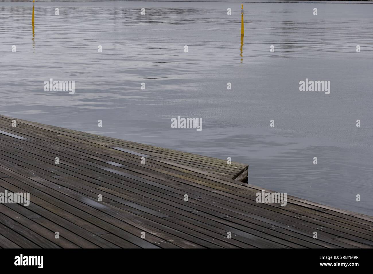 Outdoor exterior top view of wet rough wooden dock at the seaside in ...