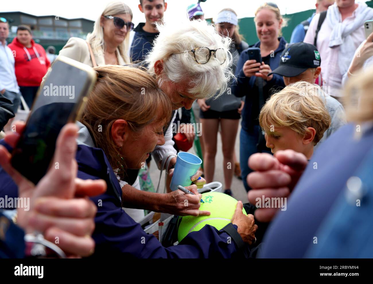 Judy Murray signs an oversized tennis ball for a fan on day nine of the ...