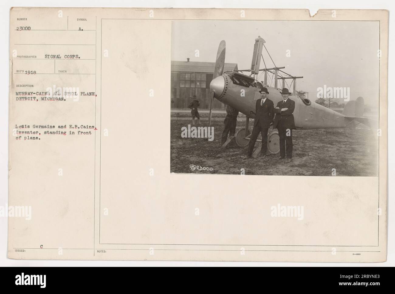 Ledis Germaine and E.P. Cains, Inventor, standing in front of an all ...