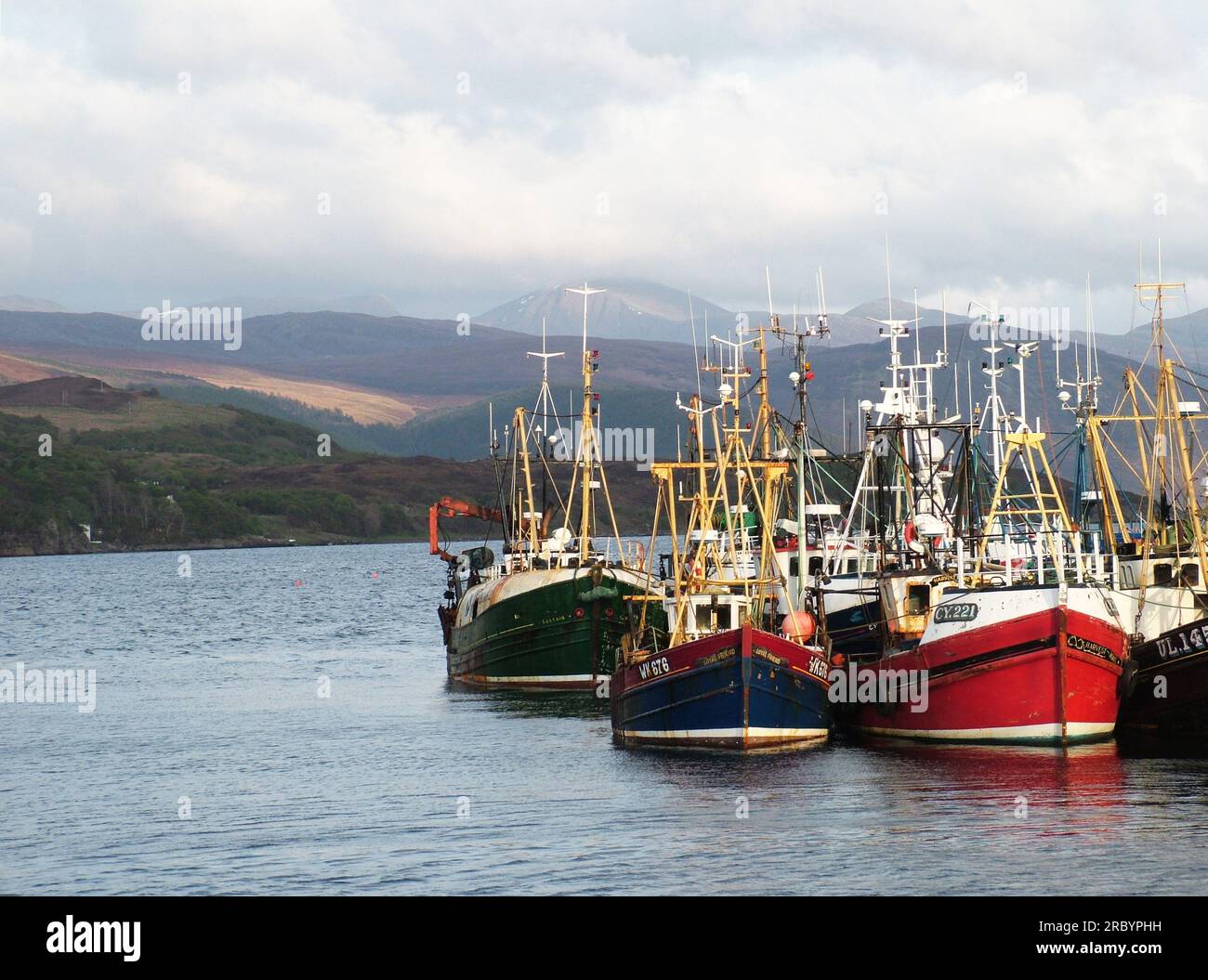 The colourfull fishing boats in the shelter of the quay at Ullapool in ...