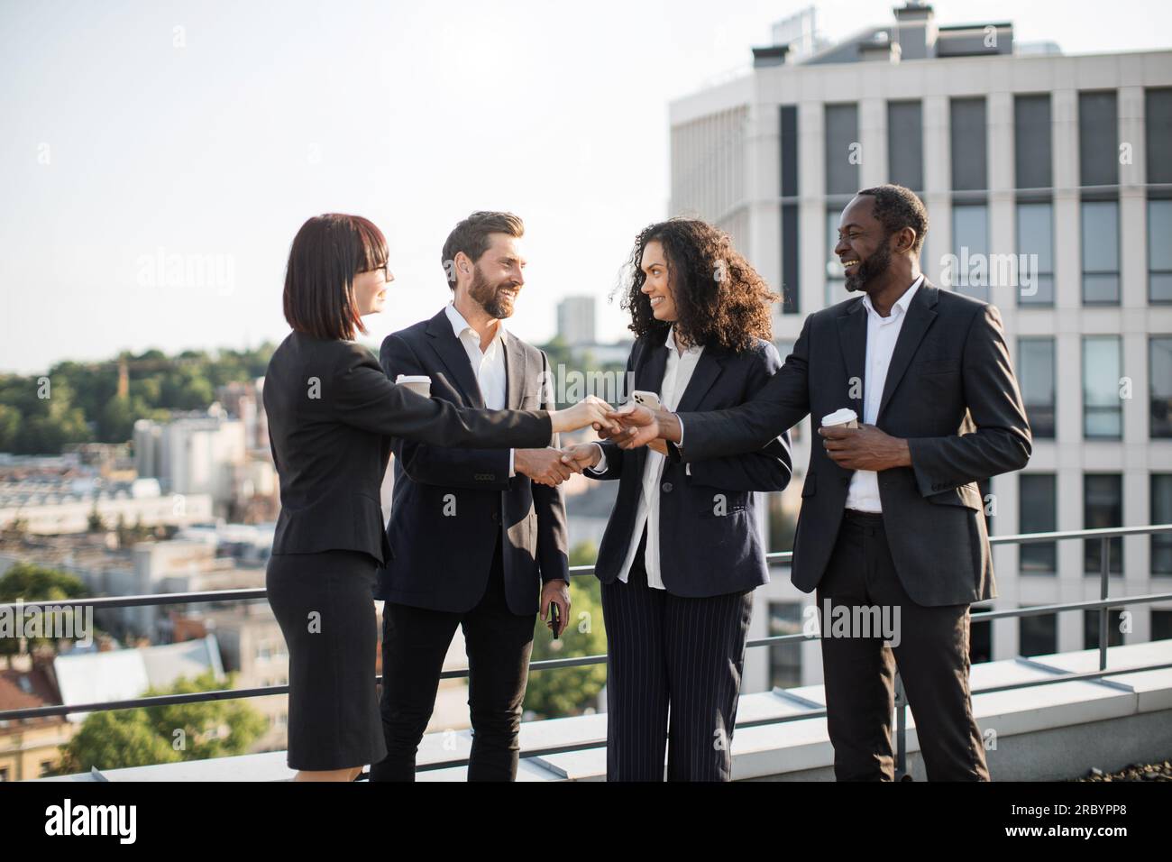 Team of foreign investors of different ethnicities shaking hands after ...