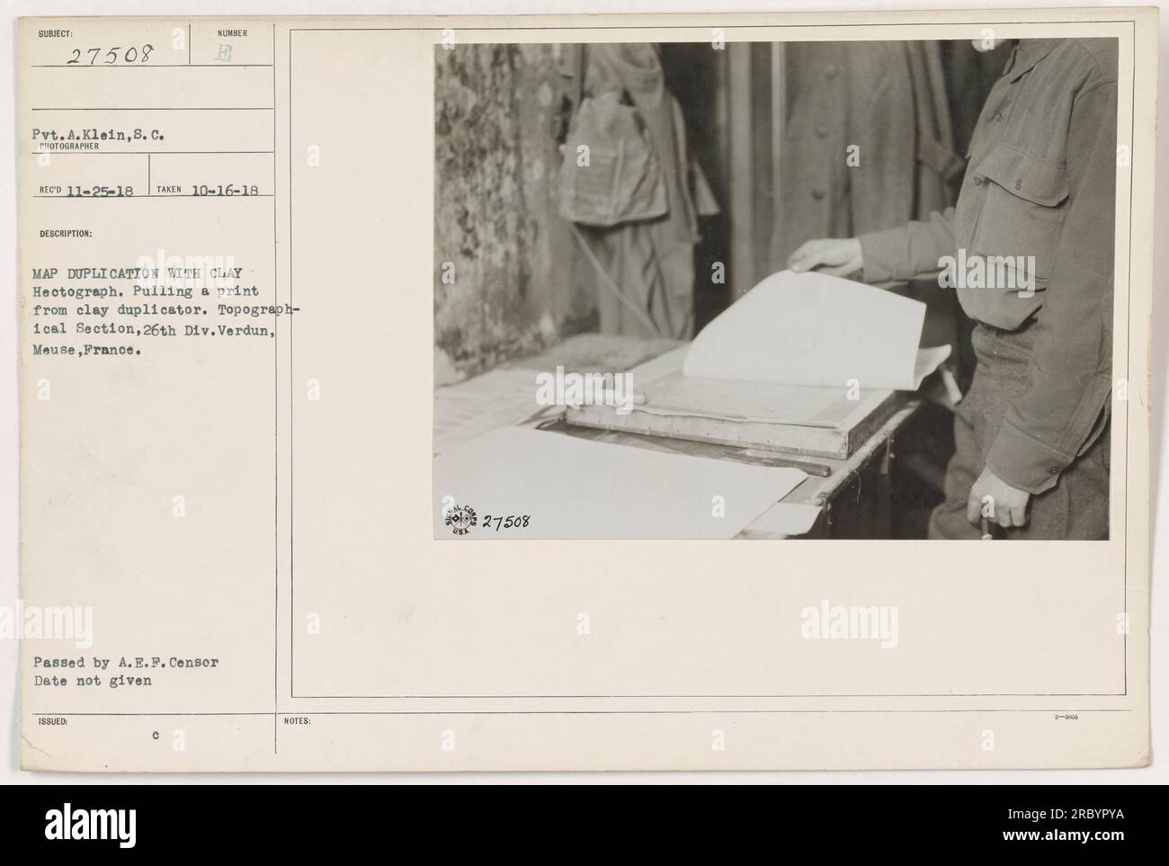 Pvt. A. Klein, S.C., is shown in the photograph pulling a print from a ...