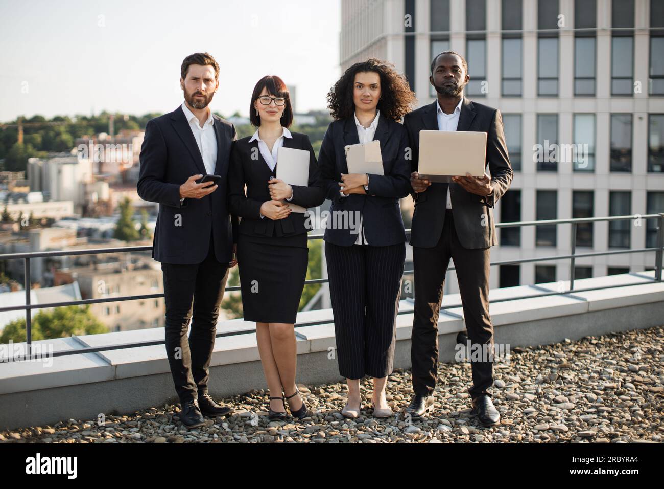 Full length portrait of four successful foreign investors dressed in ...