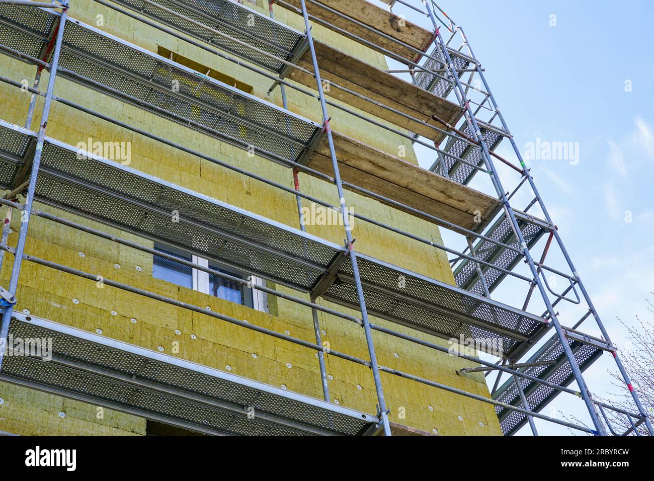 Scaffolding around the facade of the apartment building to perform ...