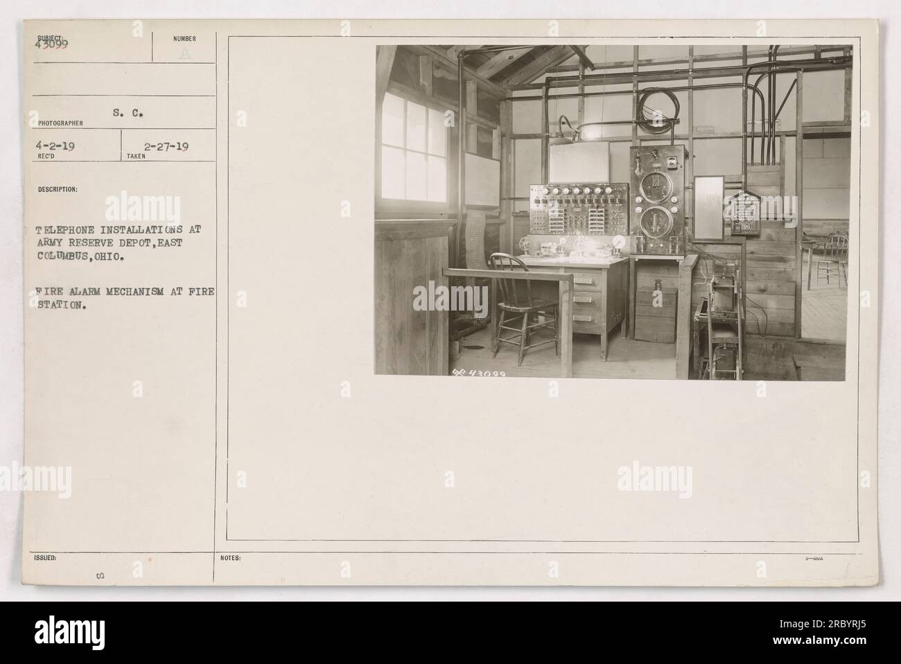 A US military personnel stands beside a fire alarm mechanism at a fire ...