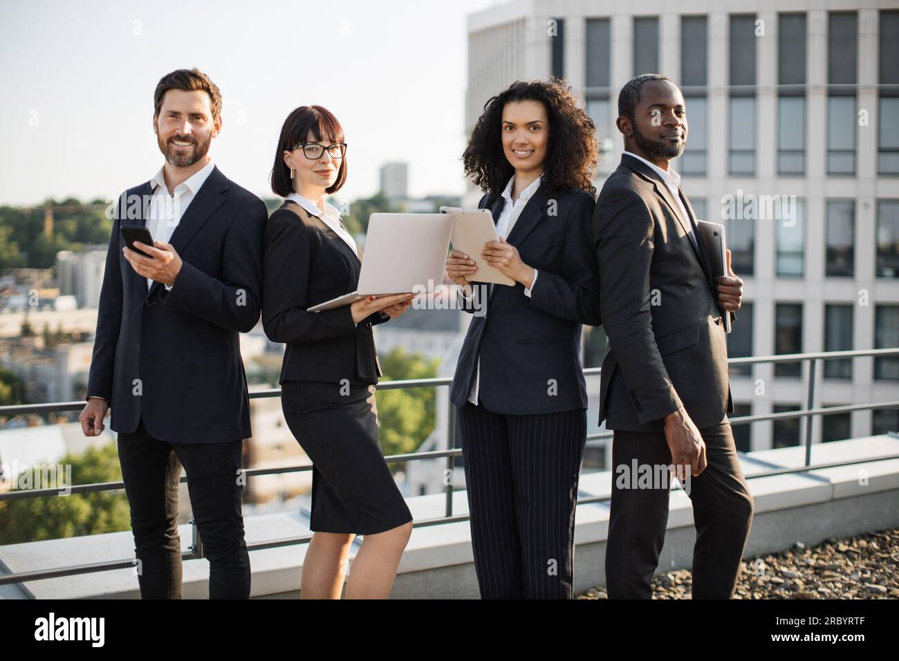 Portrait of successful international global experts standing back to ...