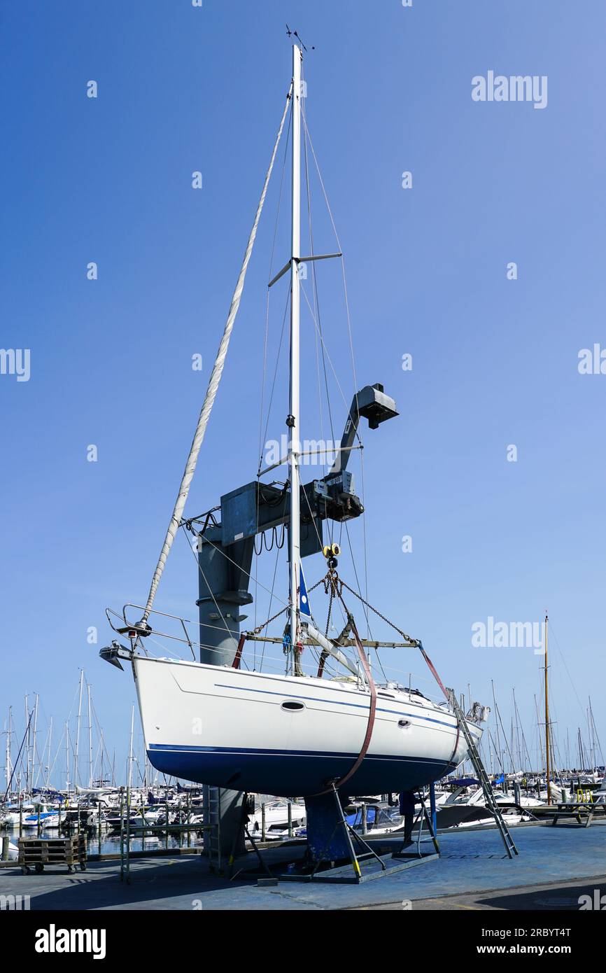 The yacht lifted ashore by a sailboat lift for the maintenance of the ...