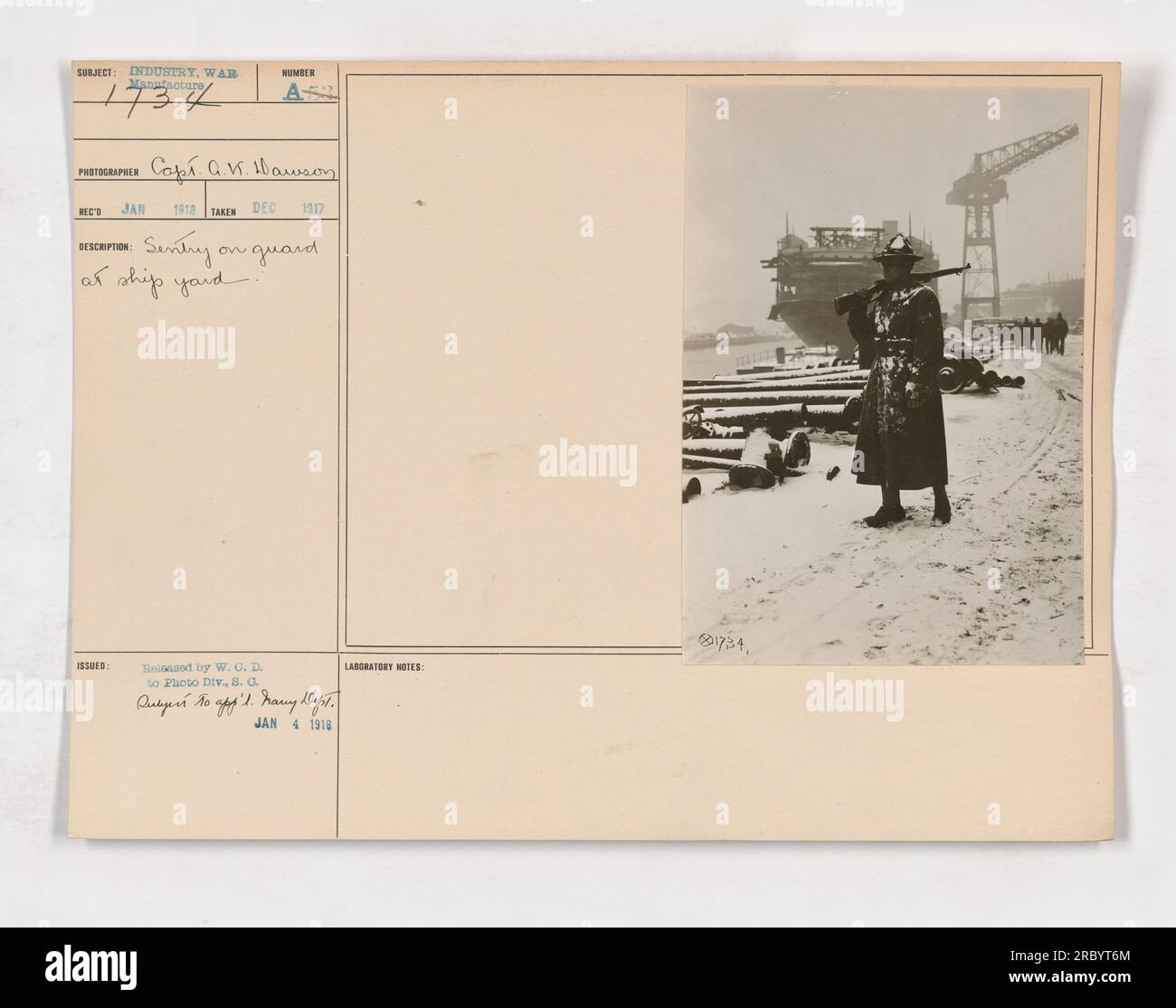 A sentry stands guard at a shipyard during World War I. The photograph ...