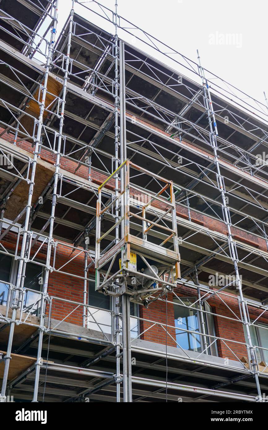 Restoration of the facade of a historic house using scaffolding with ...