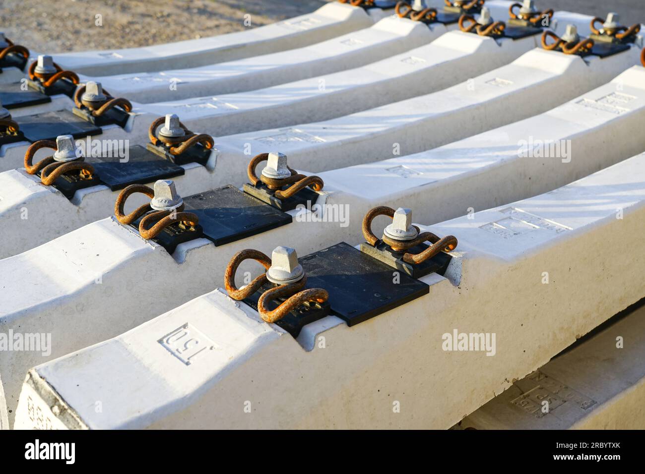 Before installation stacked new reinforced concrete railroad track ...