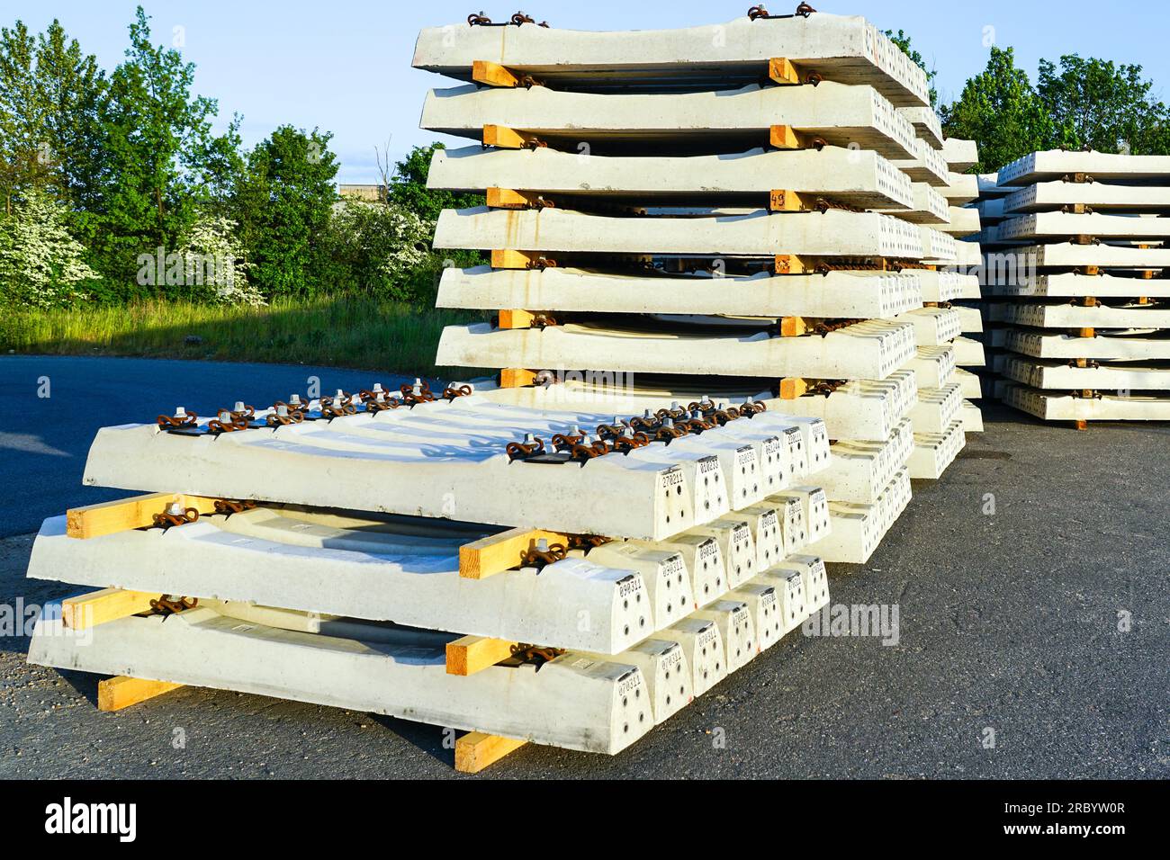 Before installation stacked new reinforced concrete railroad track ...
