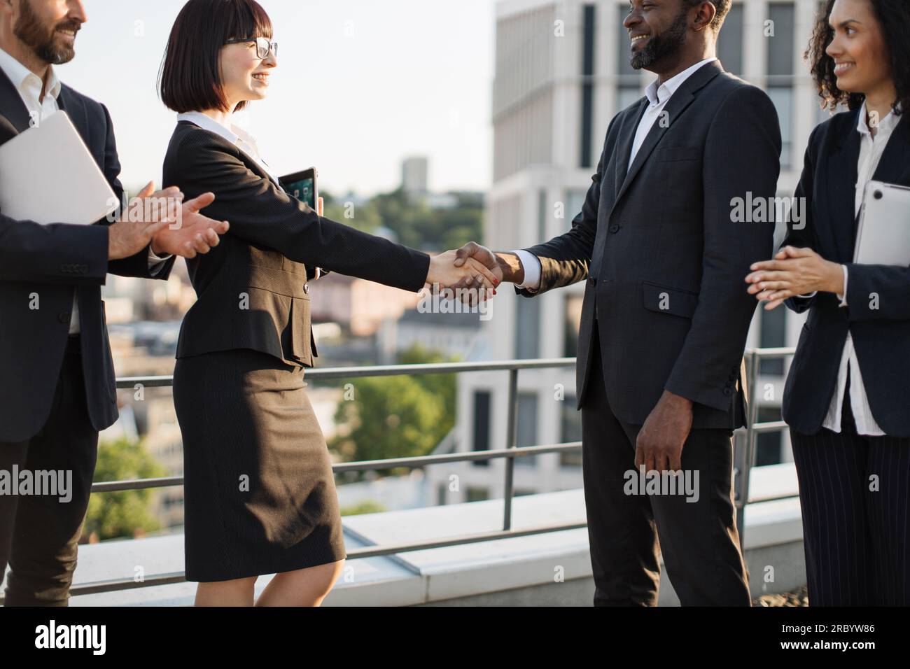 Crop of diverse business people in formal clothes making successful ...