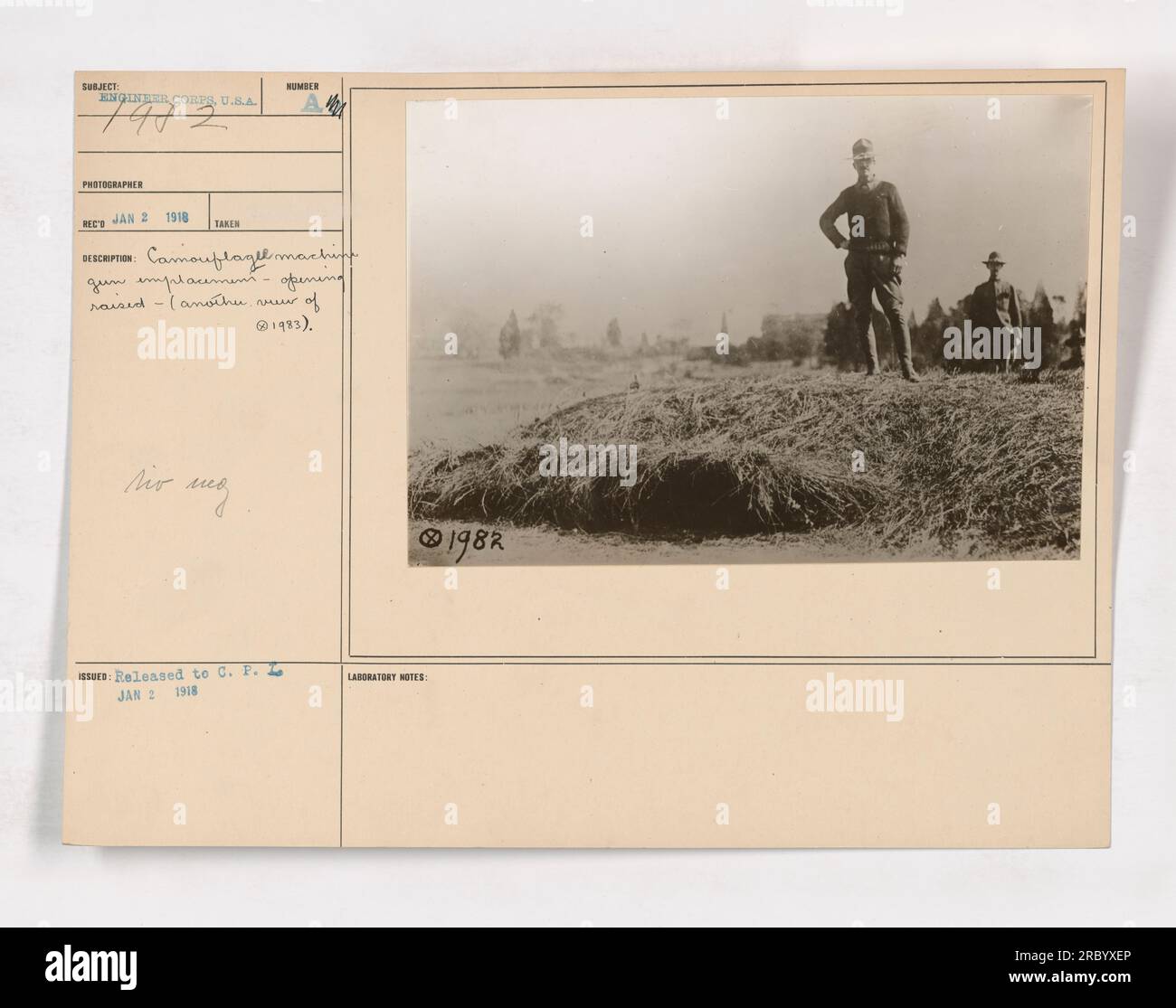 Caption: "Camouflaged machine gun emplacement in action, opening its ...