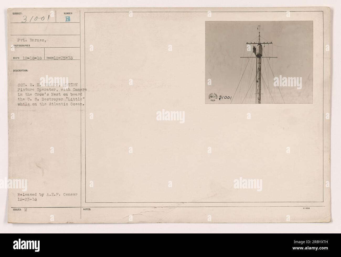 "Sgt. W.H. Thorpe, motion picture operator, operates his camera from ...