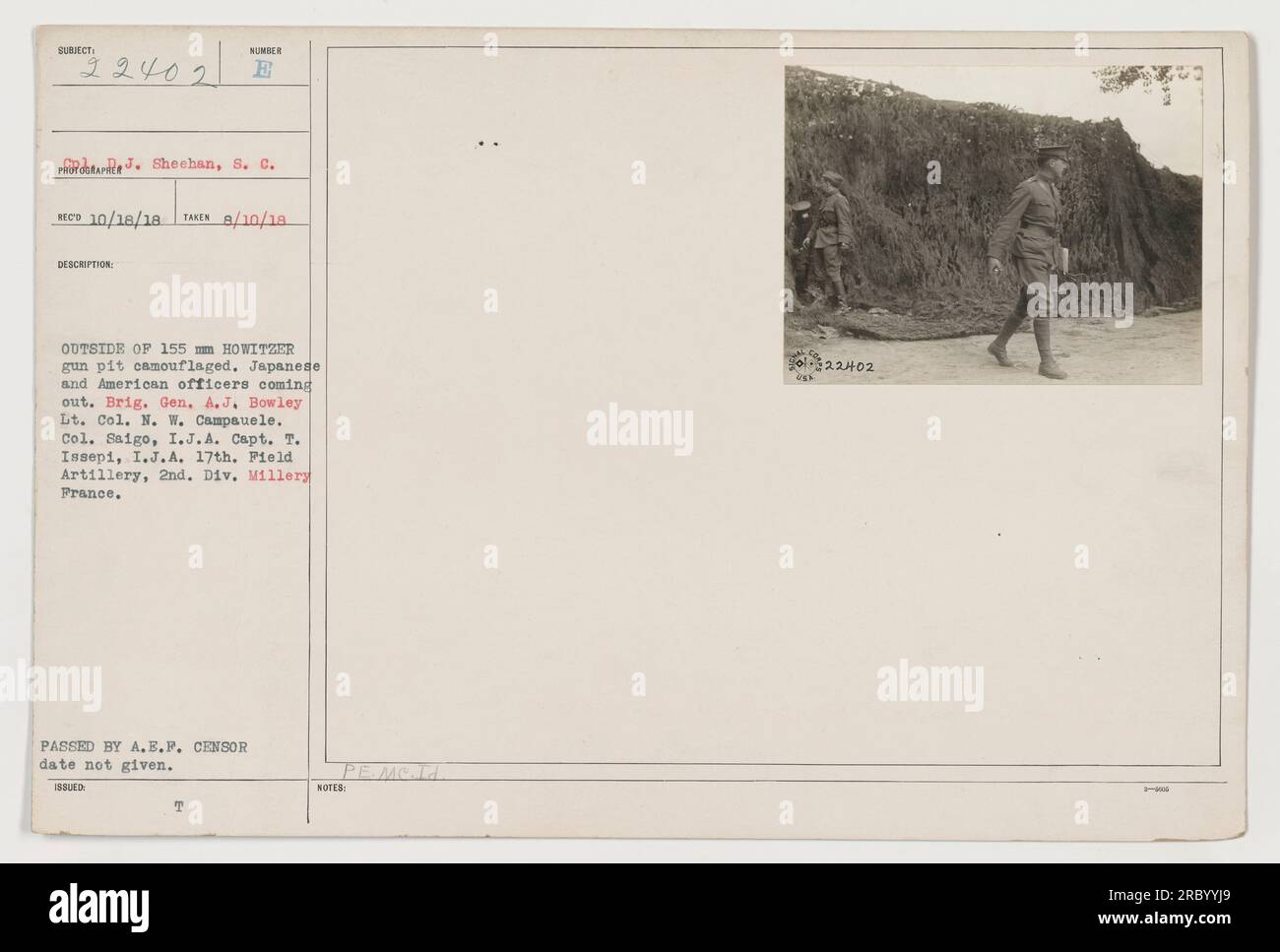 Japanese and American officers are seen coming out of a 155 Howitzer ...