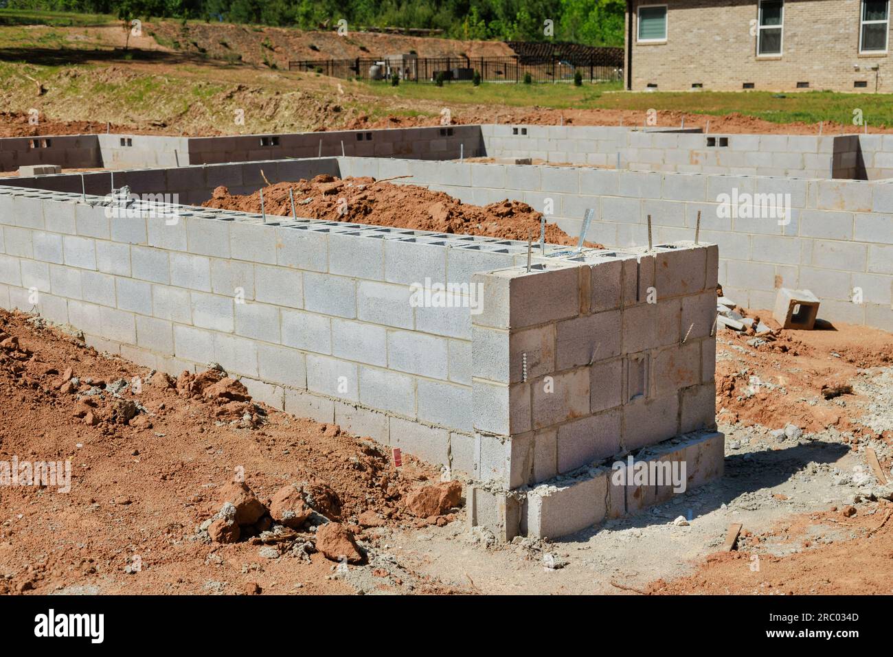 Masonry building foundation walls are located near house surrounded by ...