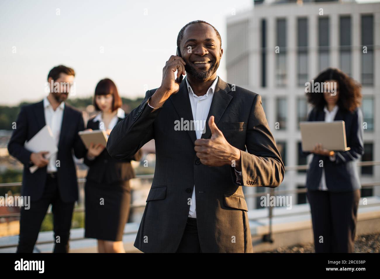 Beaming african american gentleman having conversation on smartphone ...