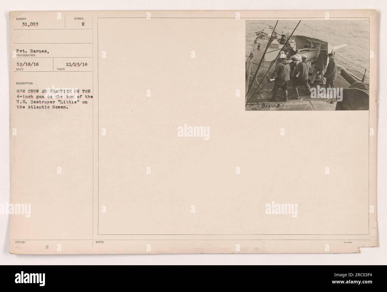 Gun crew members practicing on a 4-inch gun on the bow of the U.S ...